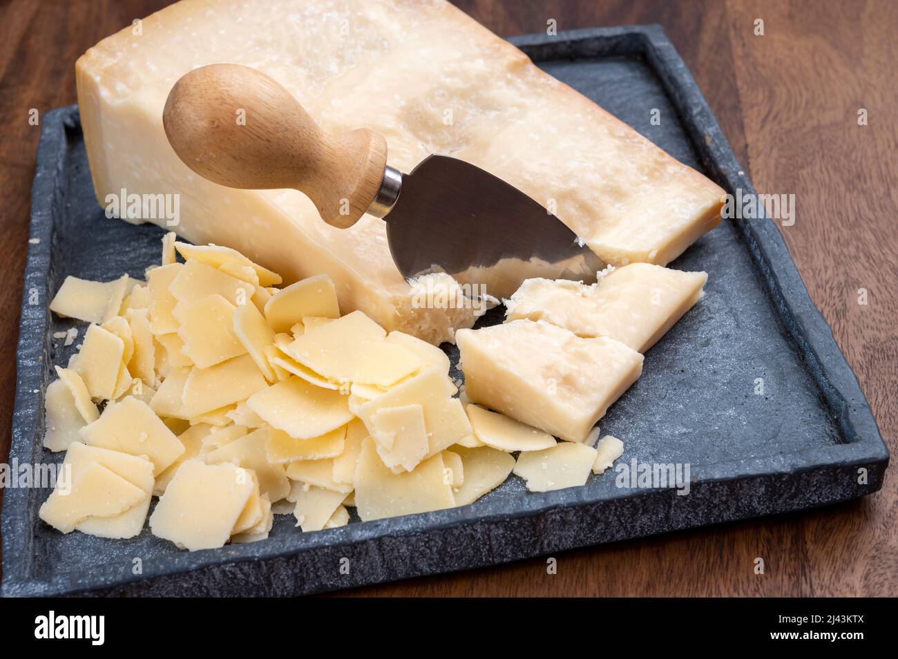 Flakes of parmesan cheese, italian hard parmigiano-reggiano cheese from ...