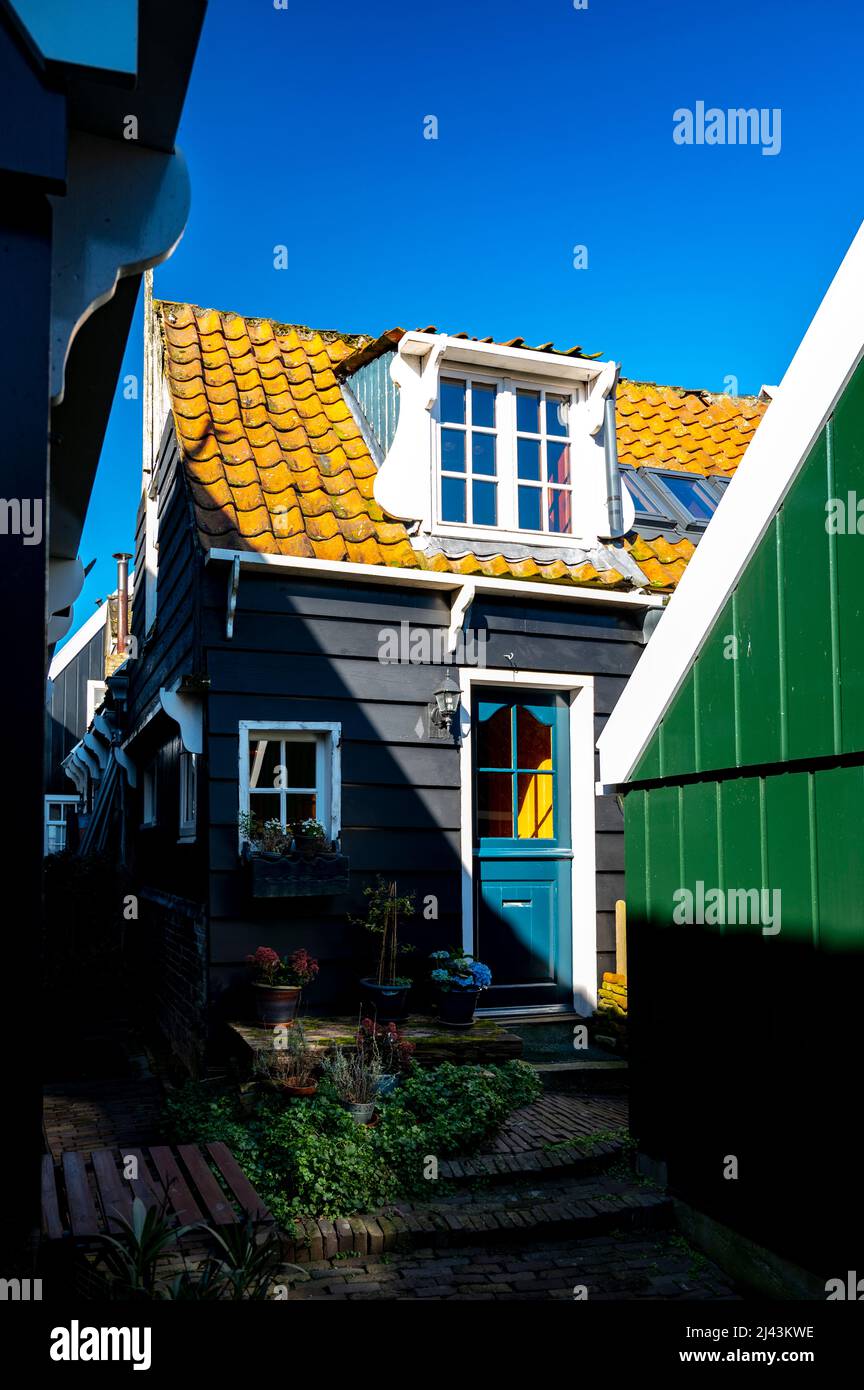 Walking on sunny spring day in small Dutch town Marken with wooden ...