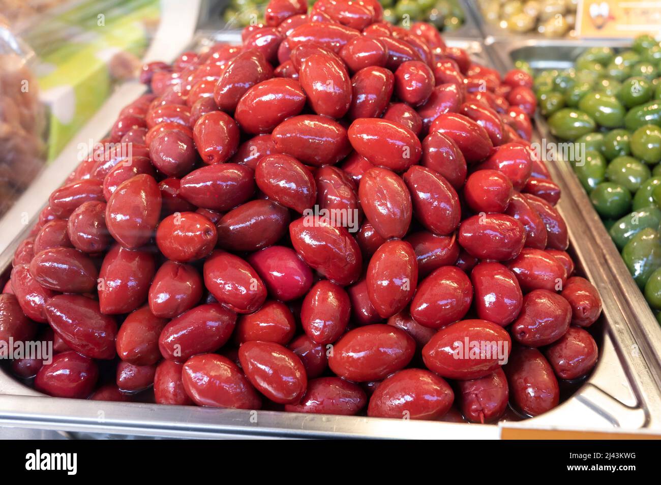 Red olives close up on market, healthy vegetarian food background Stock ...