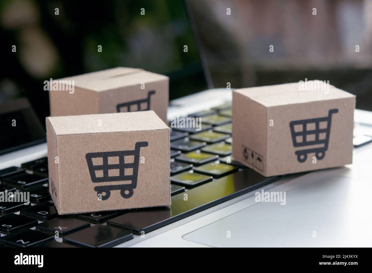 Online shopping - Paper cartons or parcel with a shopping cart logo on ...