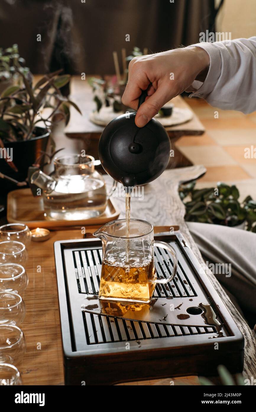Traditional Chinese tea ceremony Gun Fu Cha and pouring oolong from a ...