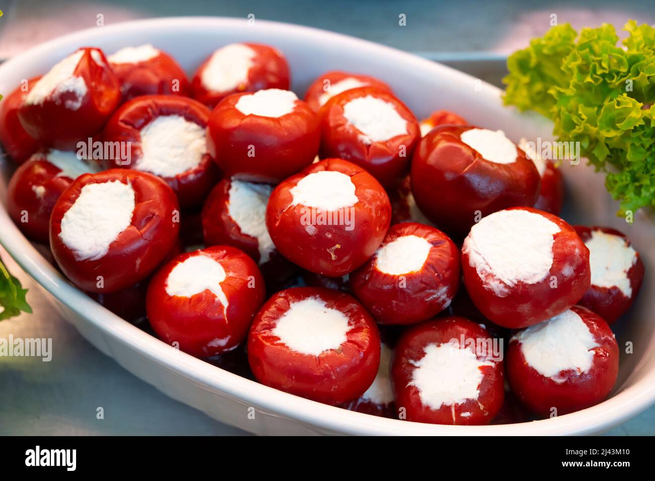 Mediterranean food, sweet red paprika pepper stuffed with soft white ...