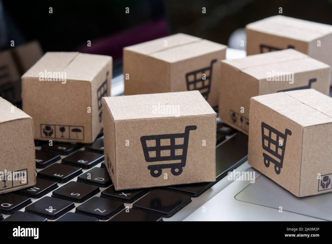 Online shopping - Paper cartons or parcel with a shopping cart logo on ...