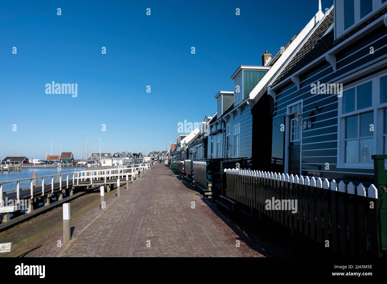 Walking on sunny spring day in small Dutch town Marken with wooden ...