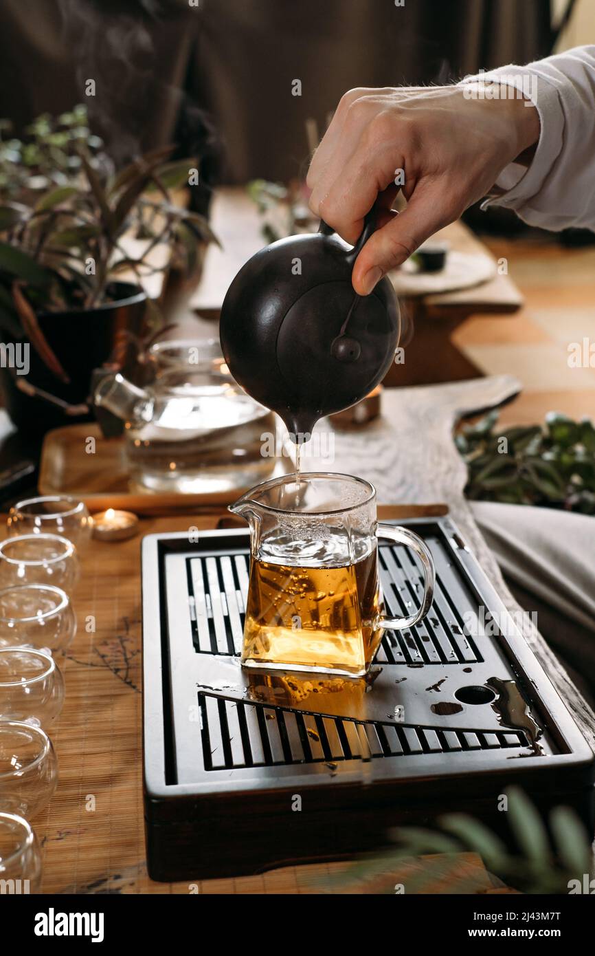 Traditional Chinese tea ceremony Gun Fu Cha and pouring oolong from a ...
