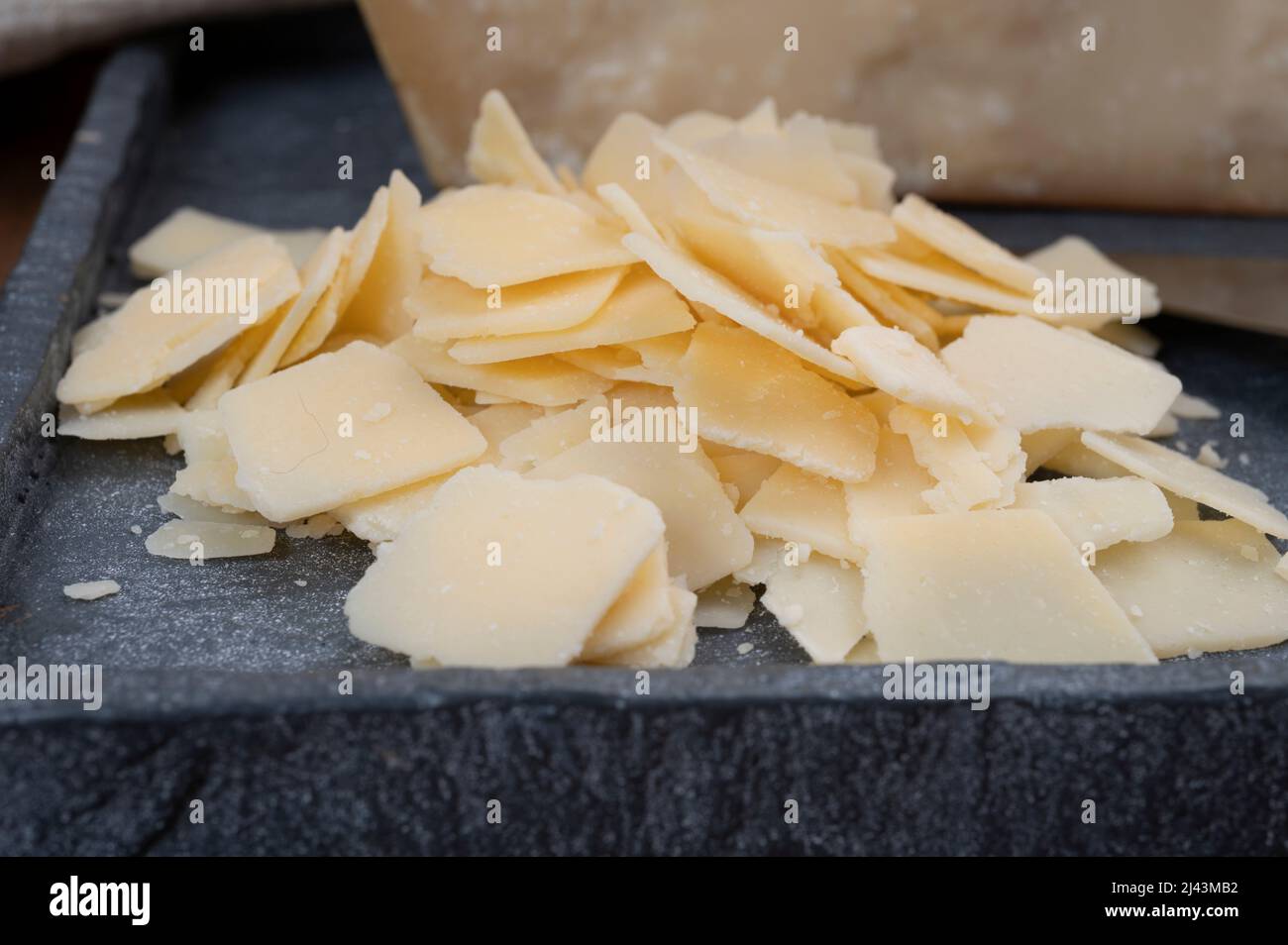 Flakes of parmesan cheese, italian hard parmigiano-reggiano cheese from ...