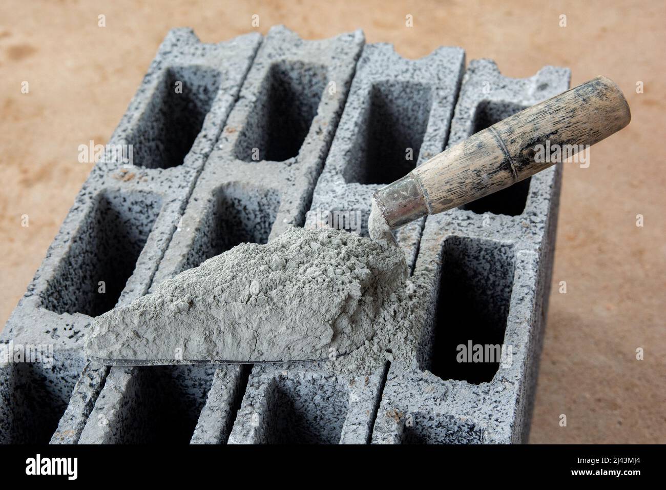 Cement powder or mortar with trowel put on the Concrete brick for ...