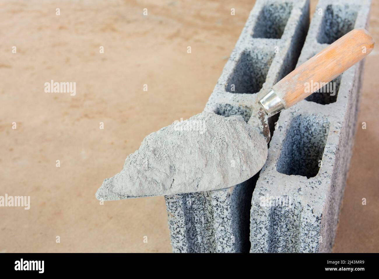 Cement powder or mortar with trowel put on the Concrete brick for ...