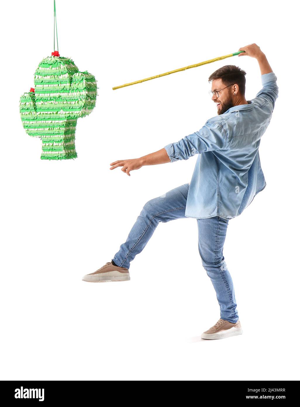 Handsome man breaking Mexican pinata on white background Stock Photo ...
