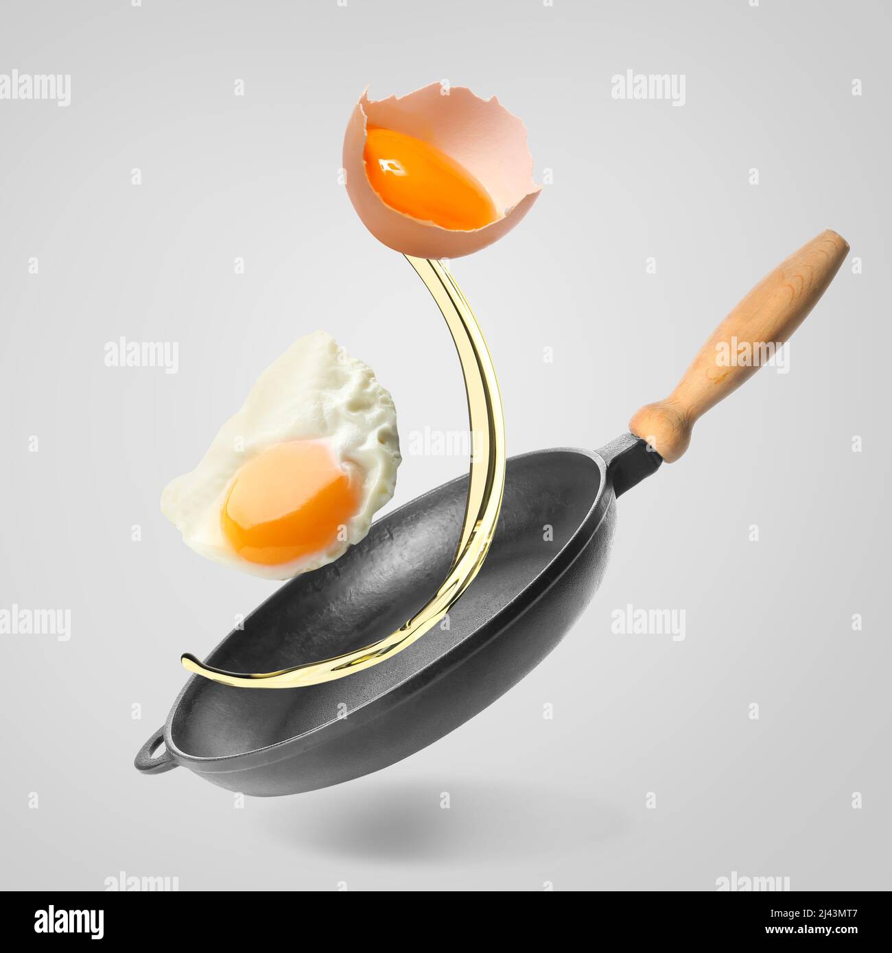 Flying frying pan, eggs and splash of oil on light background Stock ...
