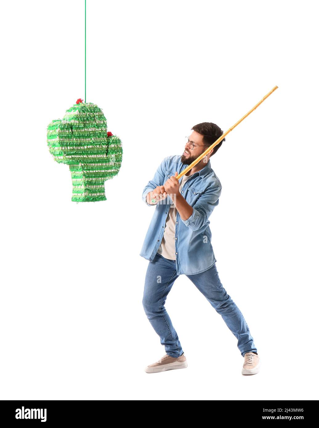 Handsome man breaking Mexican pinata on white background Stock Photo ...