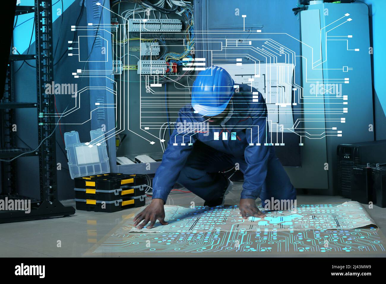African-American electrician with plan of house performing wiring Stock ...