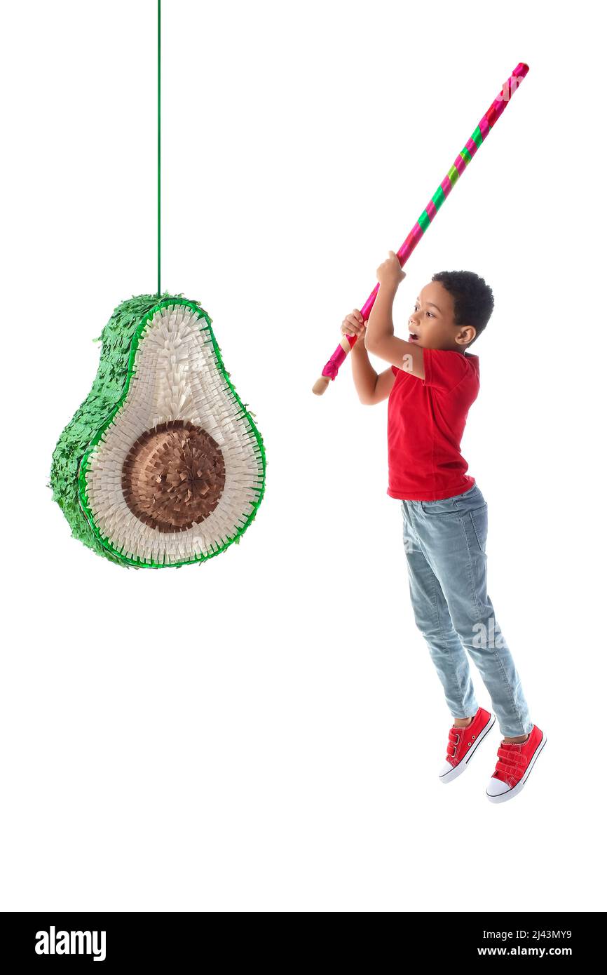 Little boy breaking Mexican pinata on white background Stock Photo - Alamy