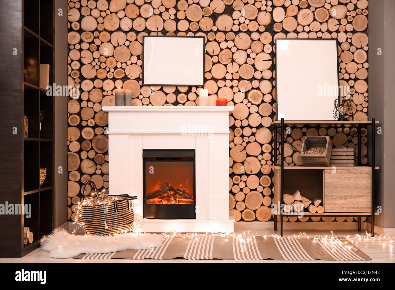 Interior of modern living room with mantelpiece, firewood and glowing ...