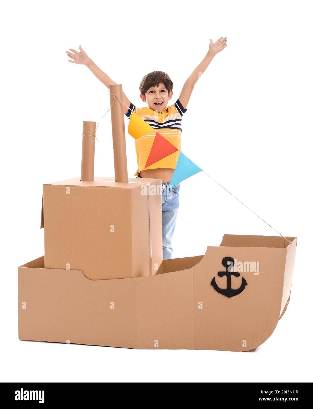 Cute little boy playing with cardboard ship on white background Stock ...