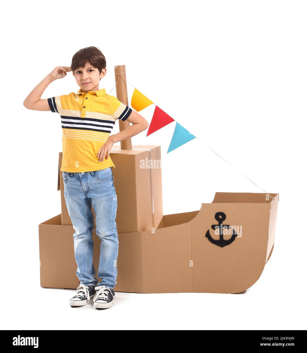 Cute little boy playing with cardboard ship on white background Stock ...
