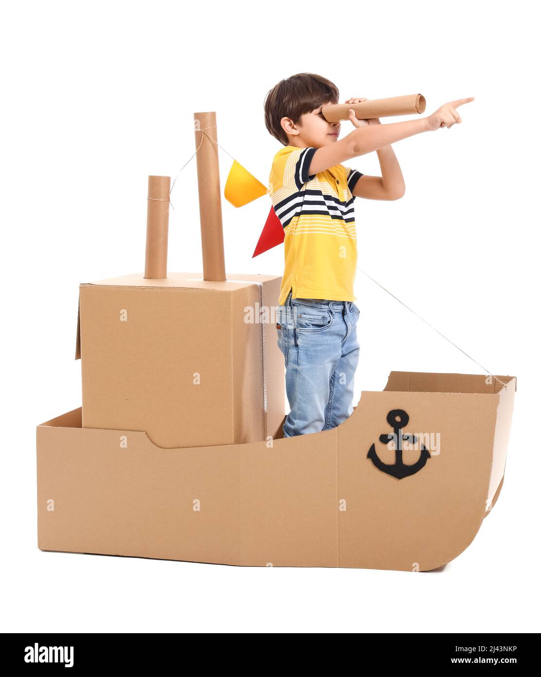 Cute little boy playing with cardboard ship on white background Stock ...