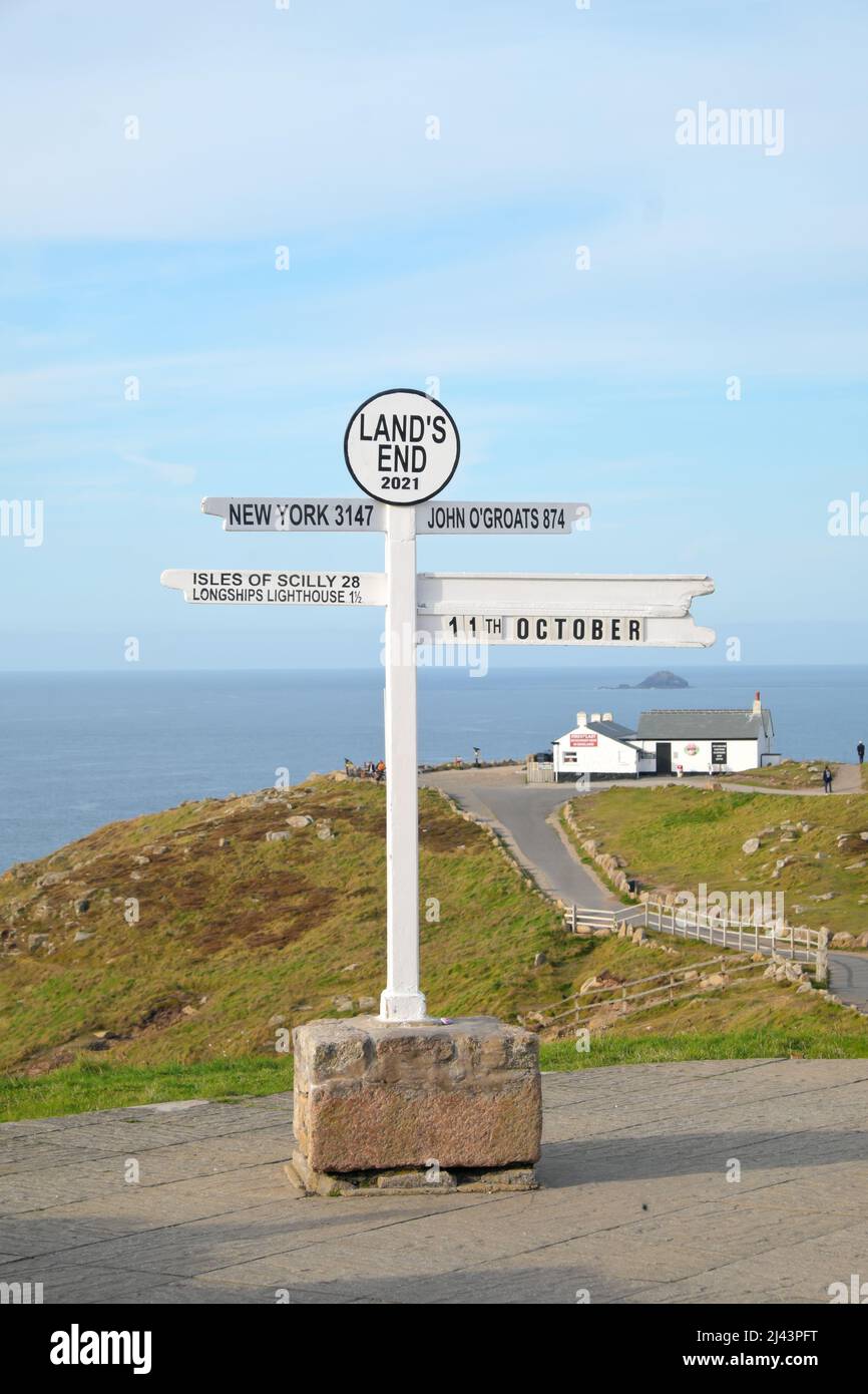 Land's End's famous signpost with the first & last house in the ...