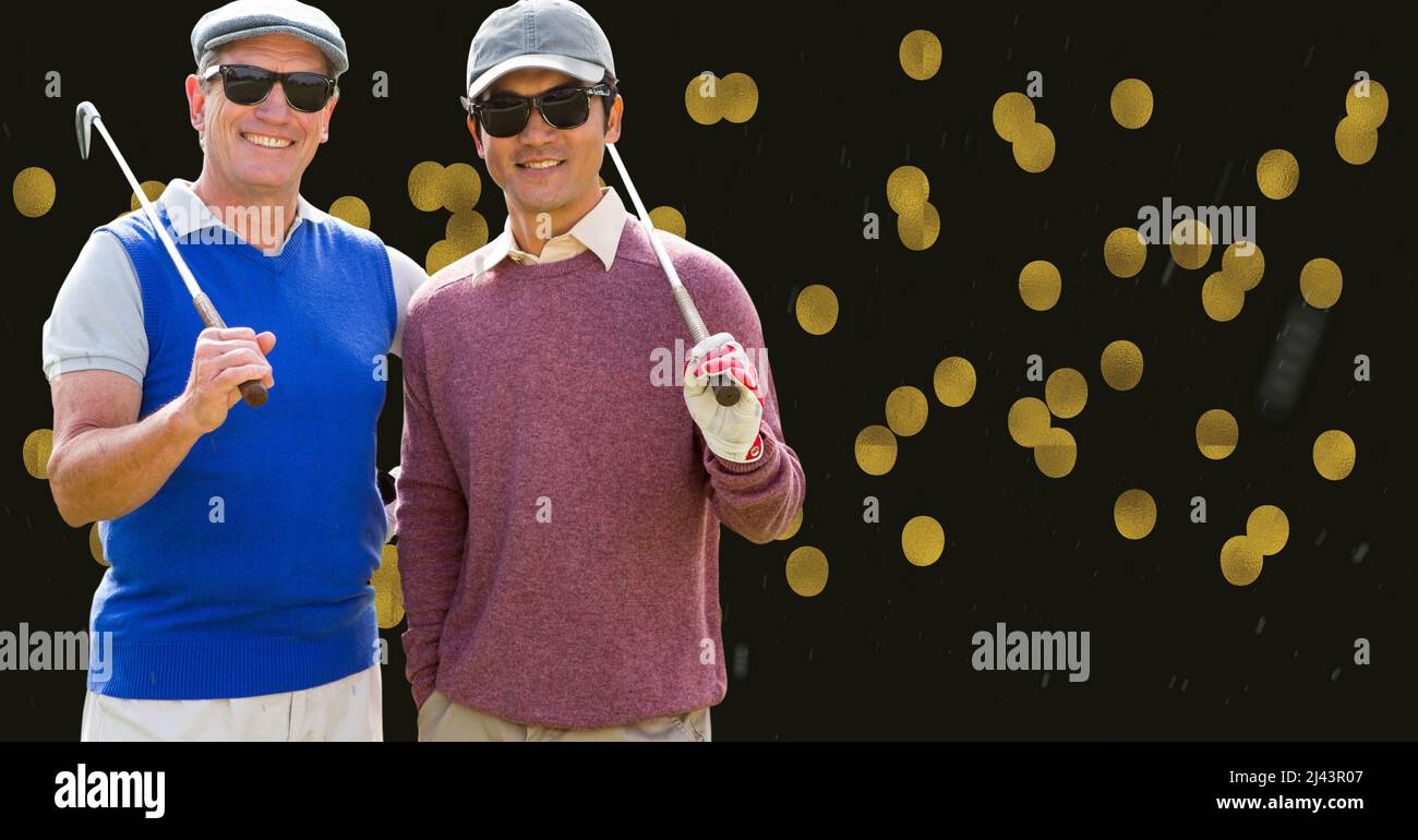 Two diverse male golf players against golden spots of light on black ...