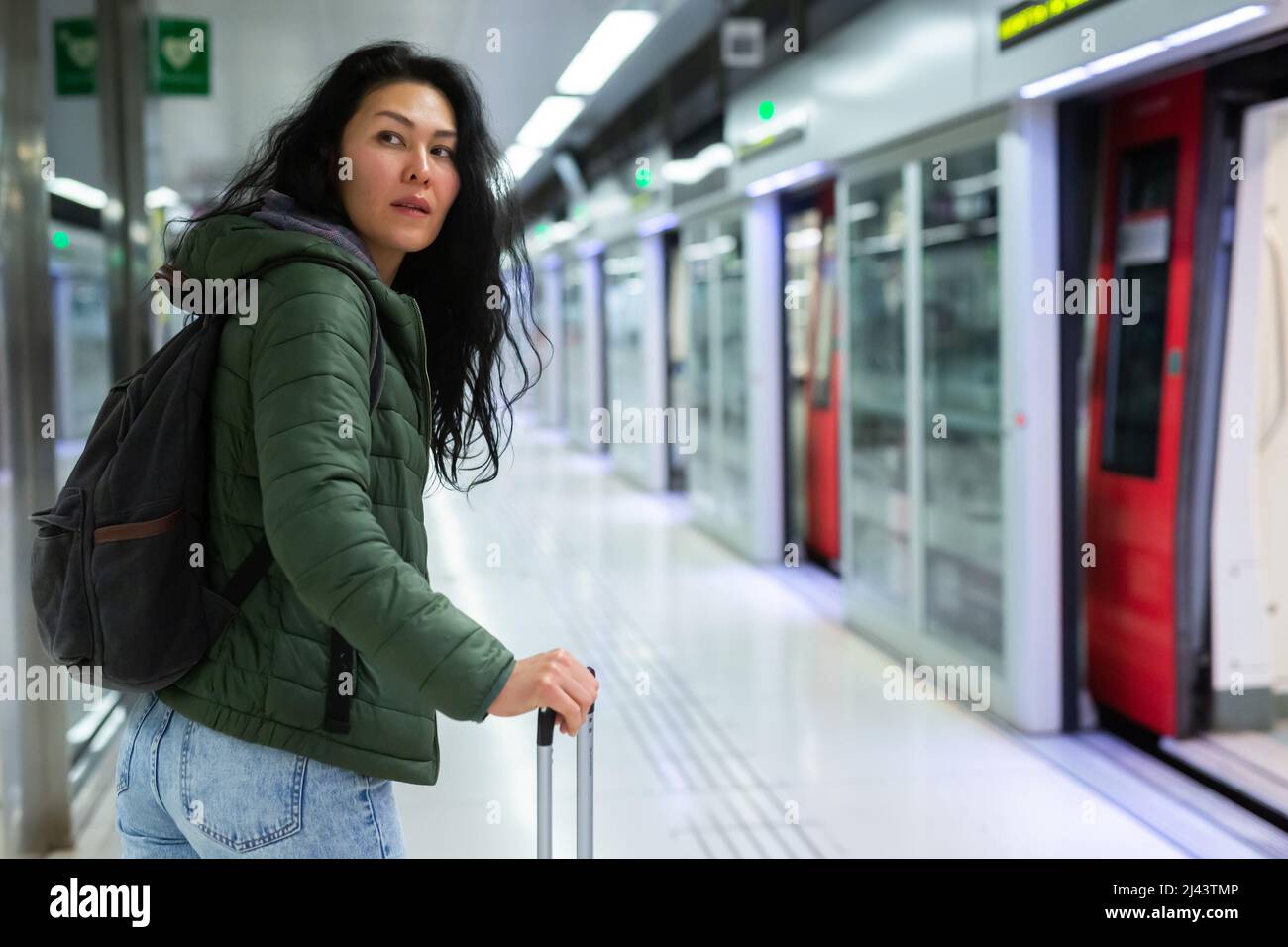 Woman going along just arrived train in subway station Stock Photo - Alamy