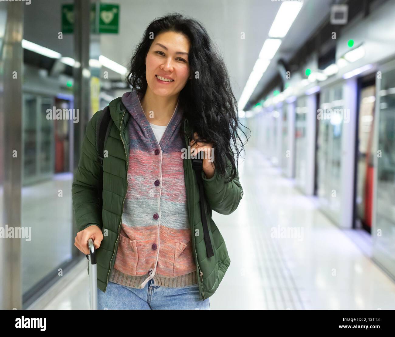 Woman going along just arrived train in subway station Stock Photo - Alamy