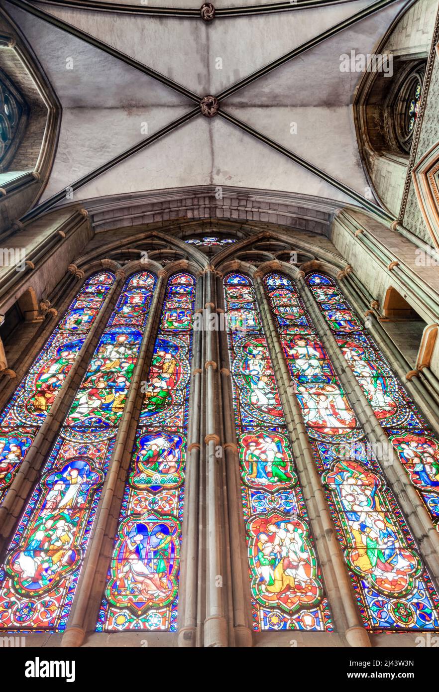 Low angle view of majestic,colorful,ornate windows, depicting religious ...