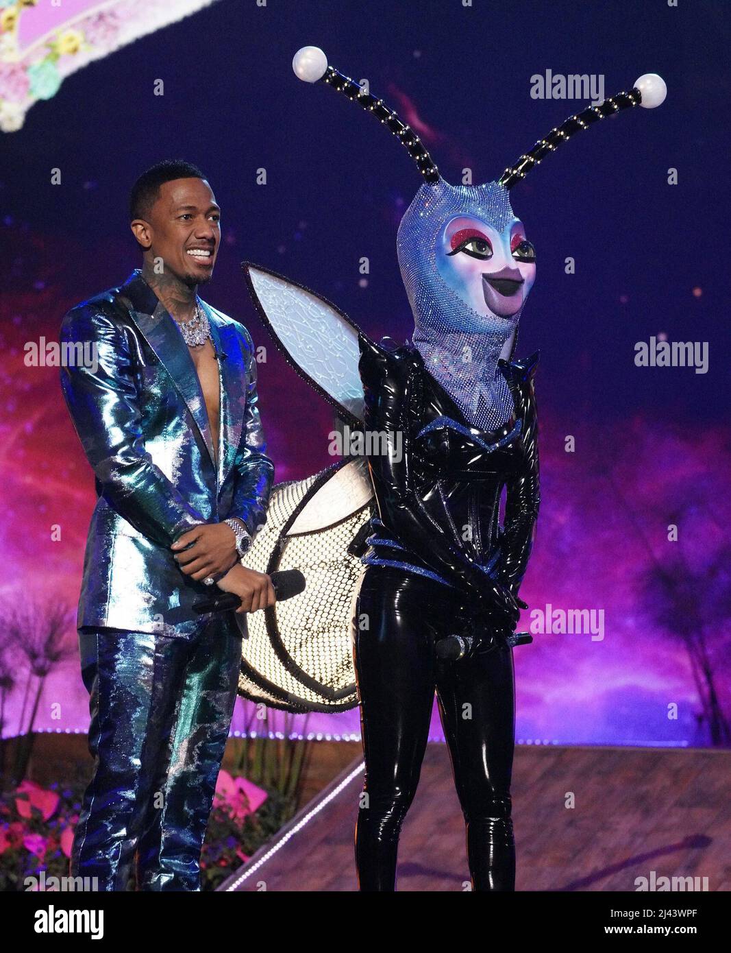 THE MASKED SINGER, from left: host Nick Cannon, Firefly, The Double ...