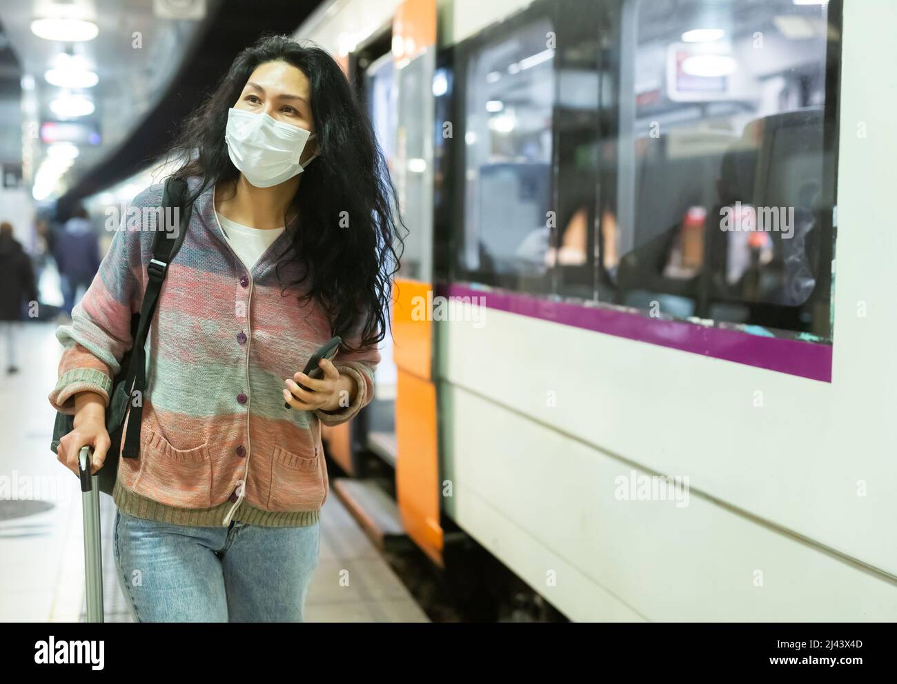 Oriental woman in protective mask going along just arrived train Stock ...