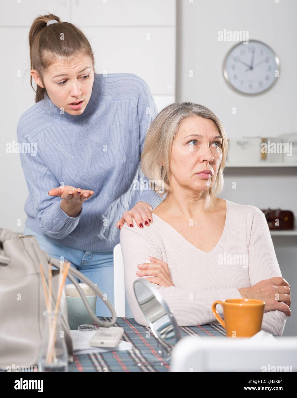 Adult daughter scolds mature mother Stock Photo - Alamy