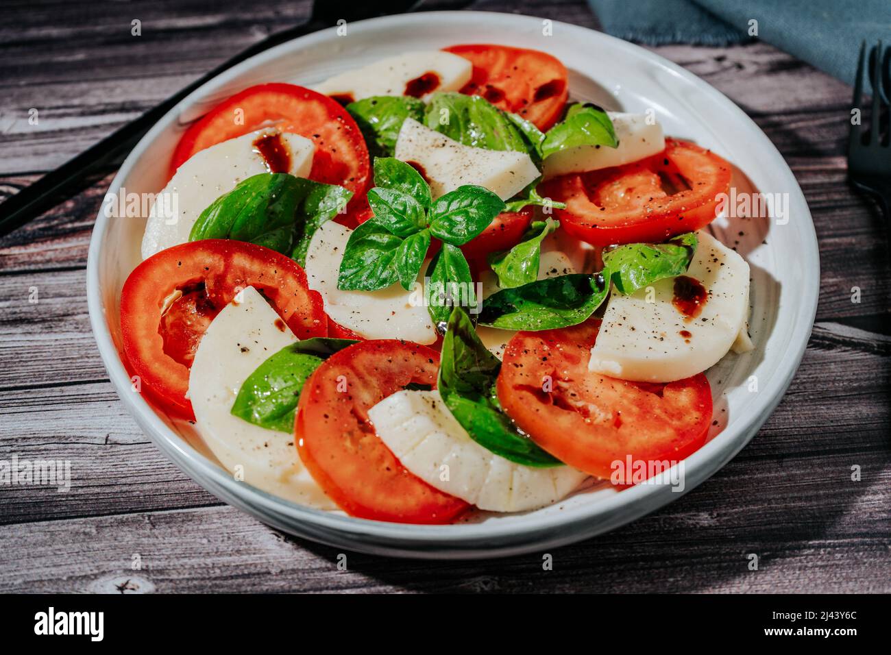 Classic Italian caprese salad of mozzarella, tomato and basil with ...