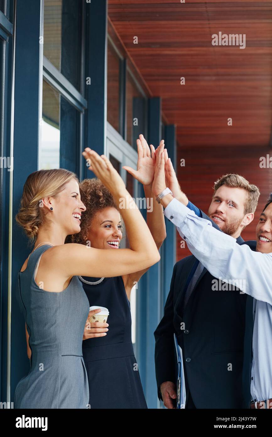 Motivated teams are strong teams. Shot of a group of motivated young ...