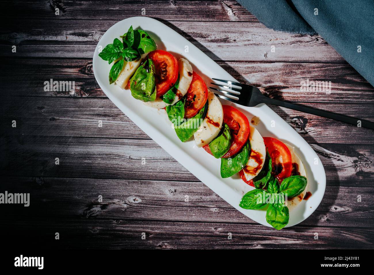 Classic Italian caprese salad of mozzarella, tomato and basil with ...