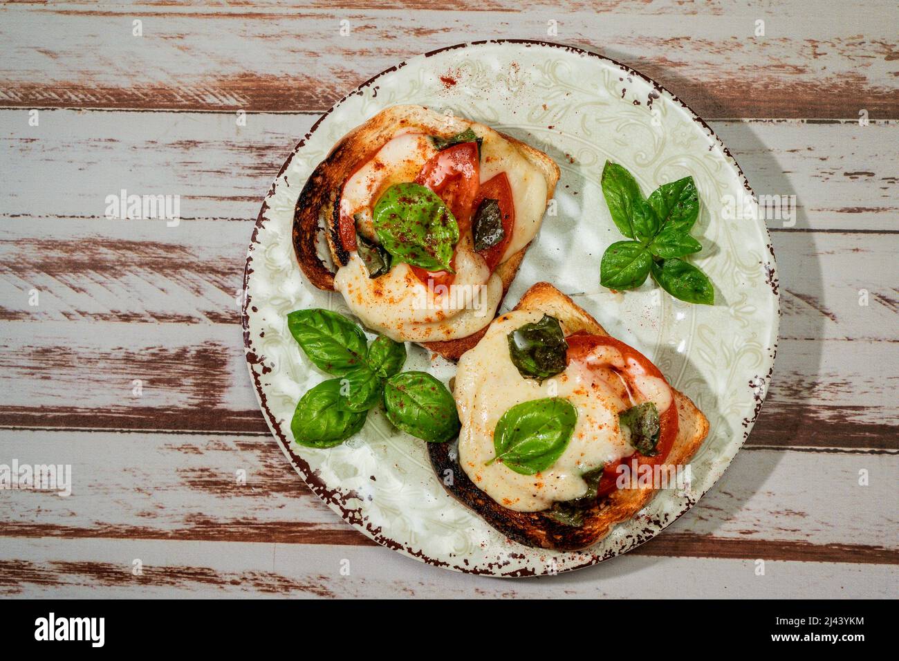 Top view of a Brusqueta with mozzarella caprese, tomato and hot basil ...
