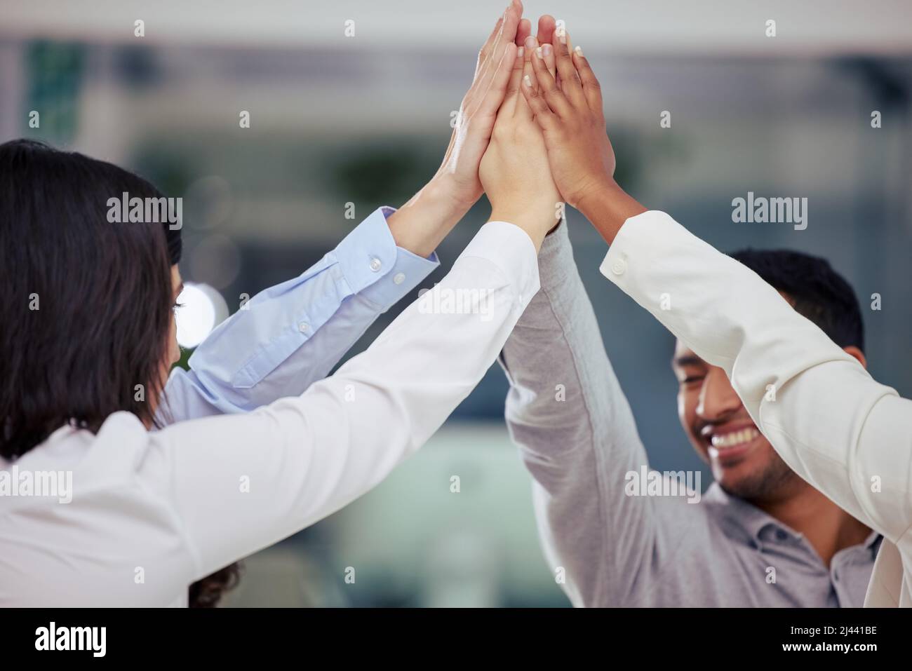 High five for a good days work. Shot of a group of businesspeople ...