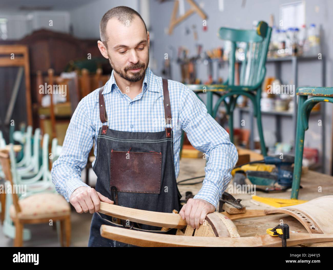 Cheerful craftsman posing in studio Stock Photo - Alamy