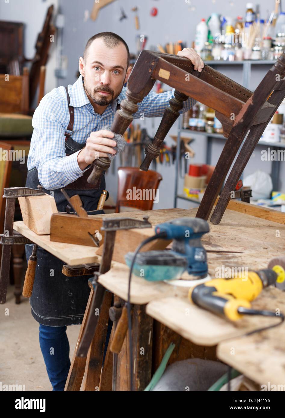 Carpenter repairing antique chair Stock Photo - Alamy