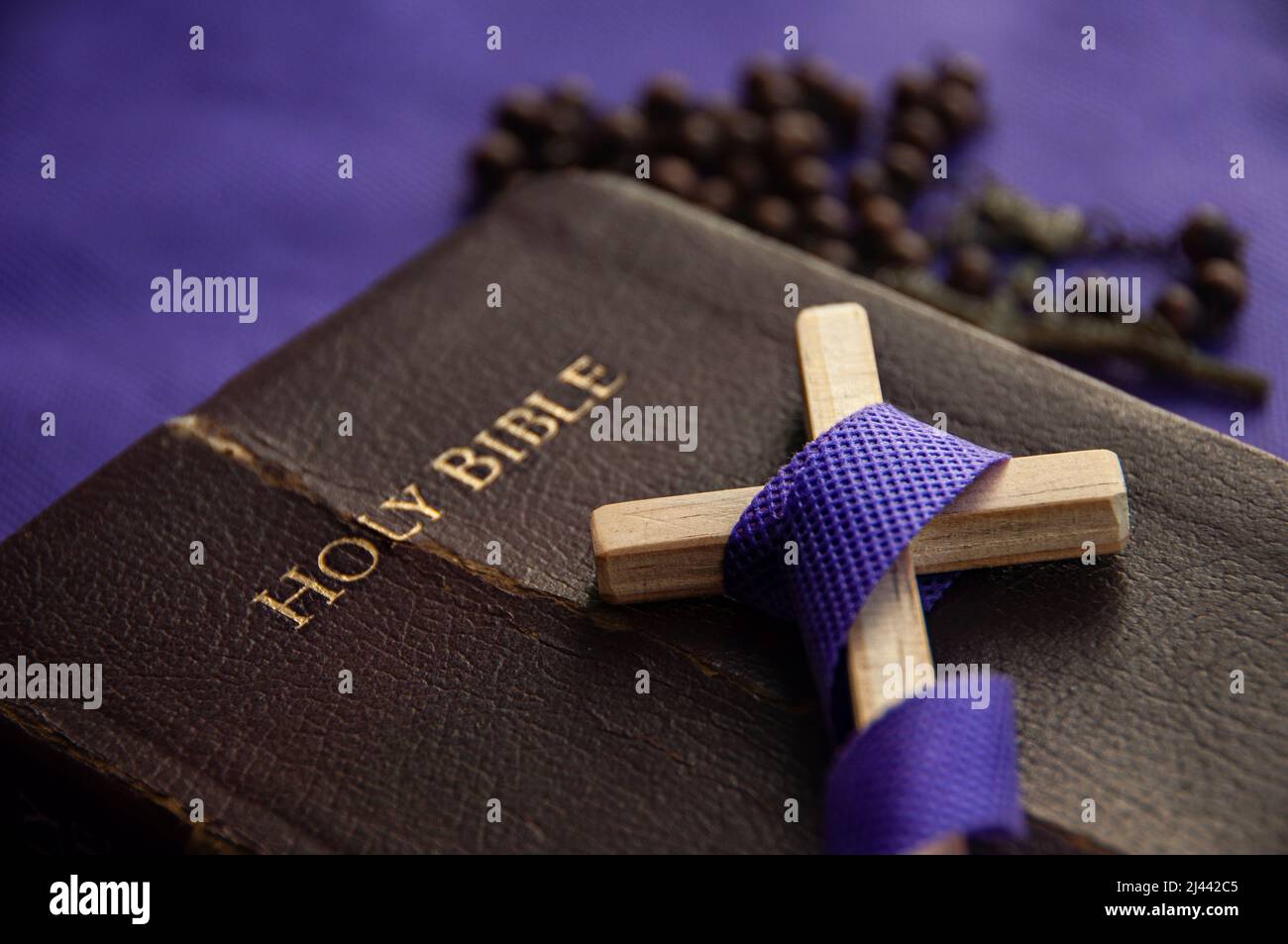 Holy cross on Bible with Rosary and purple cover background. Religious ...