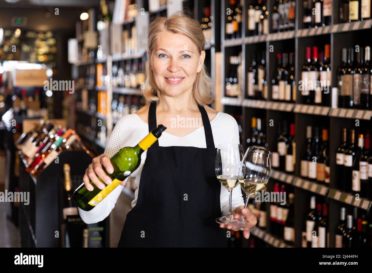 Female vintner proposing degustation of wine Stock Photo - Alamy