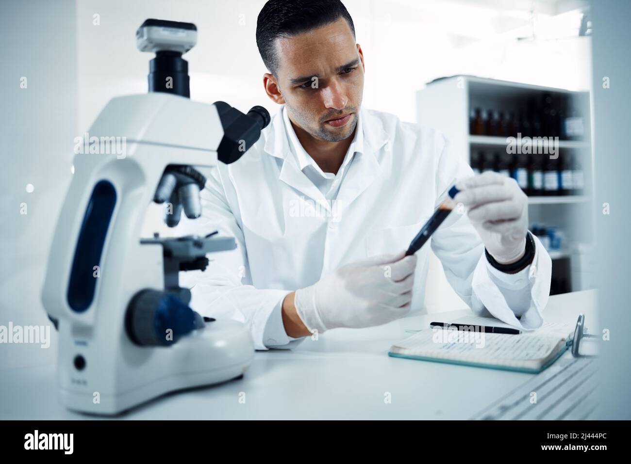 Whats present in this patients blood. Shot of a young scientist ...