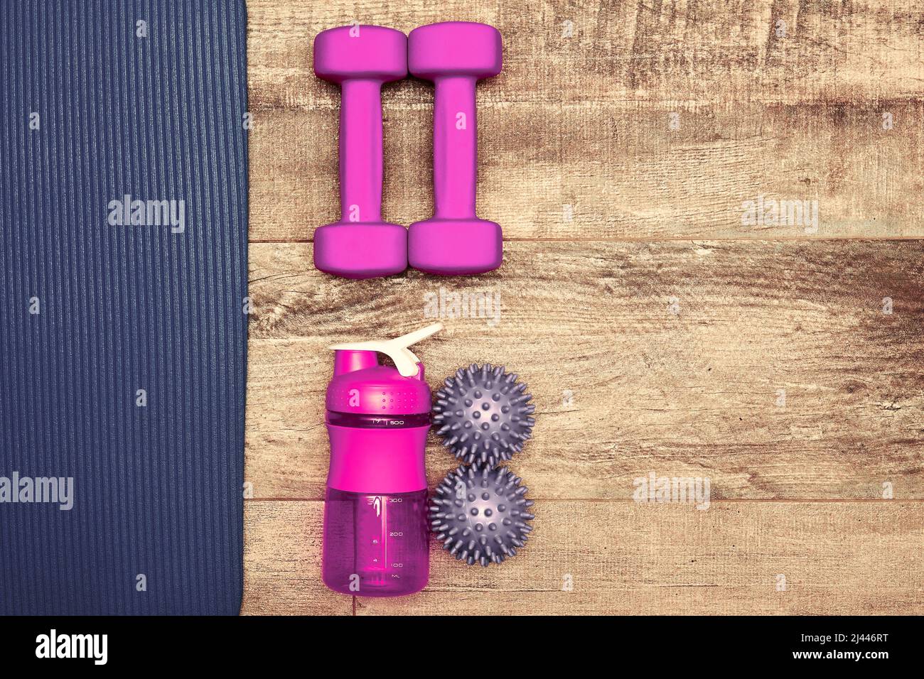 Purple fitness equipment on the wooden floor in the gym. Sports and ...