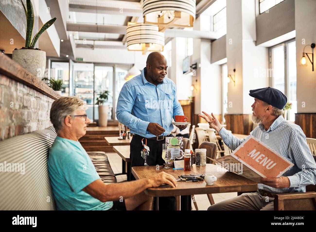 Finally, my coffee is here. Shot of two senior friends placing an order ...