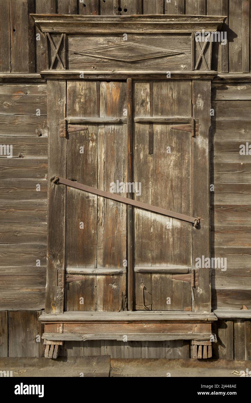 A real authentic vintage closed wooden window in gray brown grunge ...