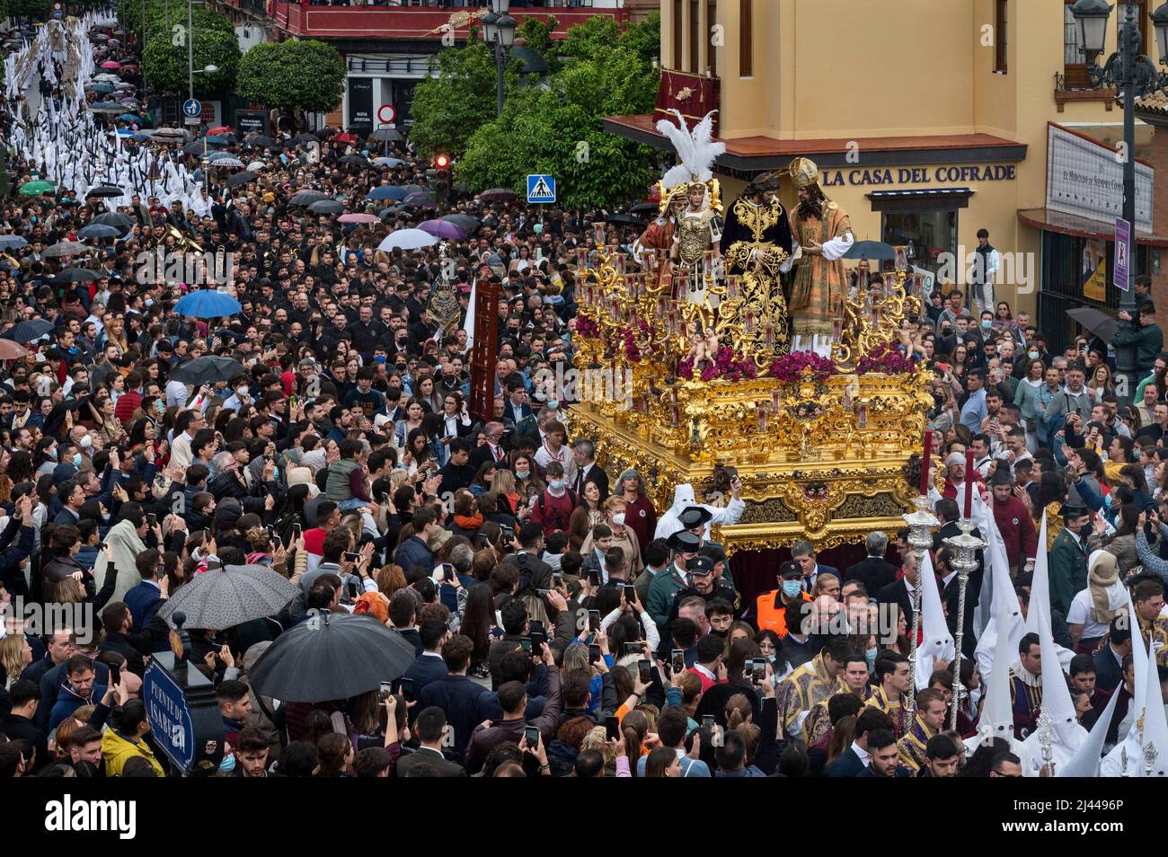 Penitents march during a procession as they carry the image of Jesus ...