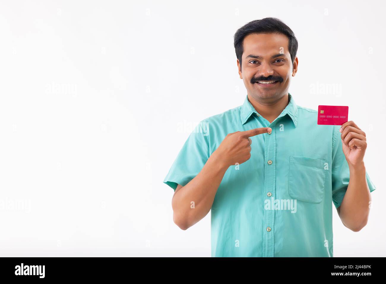 Portrait of a man pointing at credit card in his hand Stock Photo - Alamy