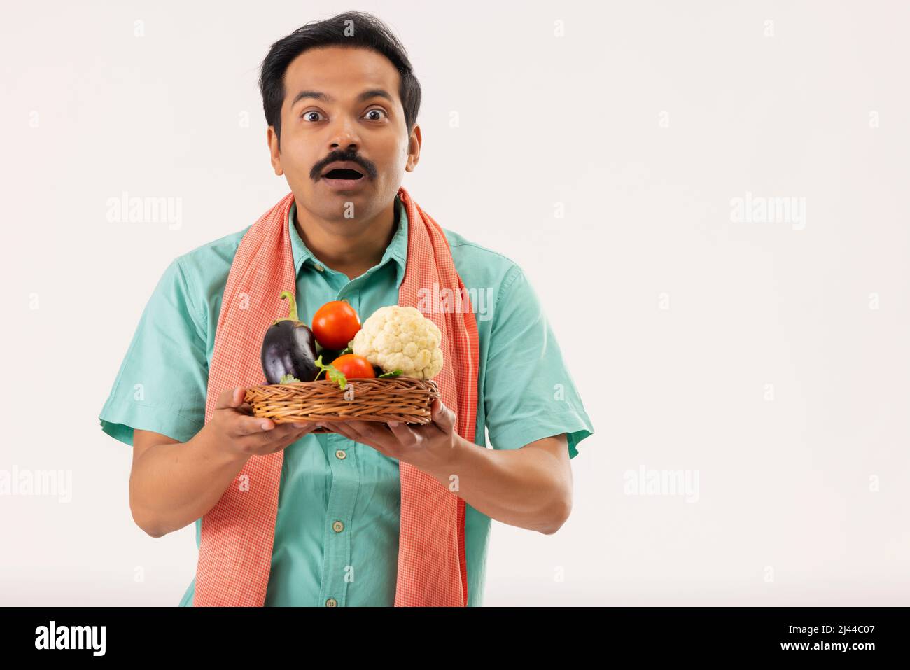 Portrait of a surprised cook servant with vegetable basket Stock Photo ...