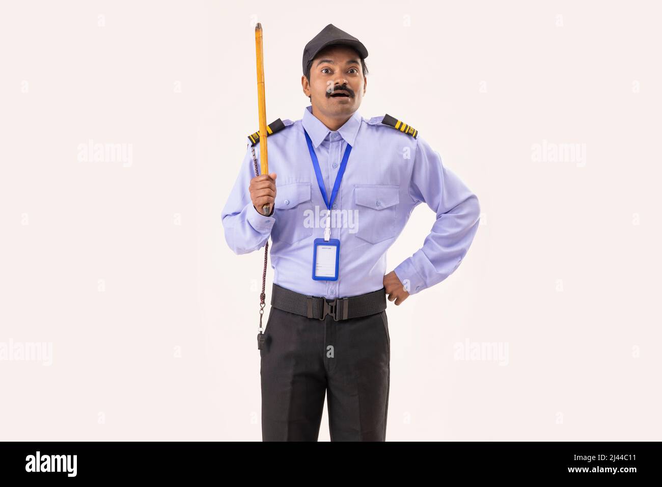Portrait of Security guard standing with stick in his hand Stock Photo ...