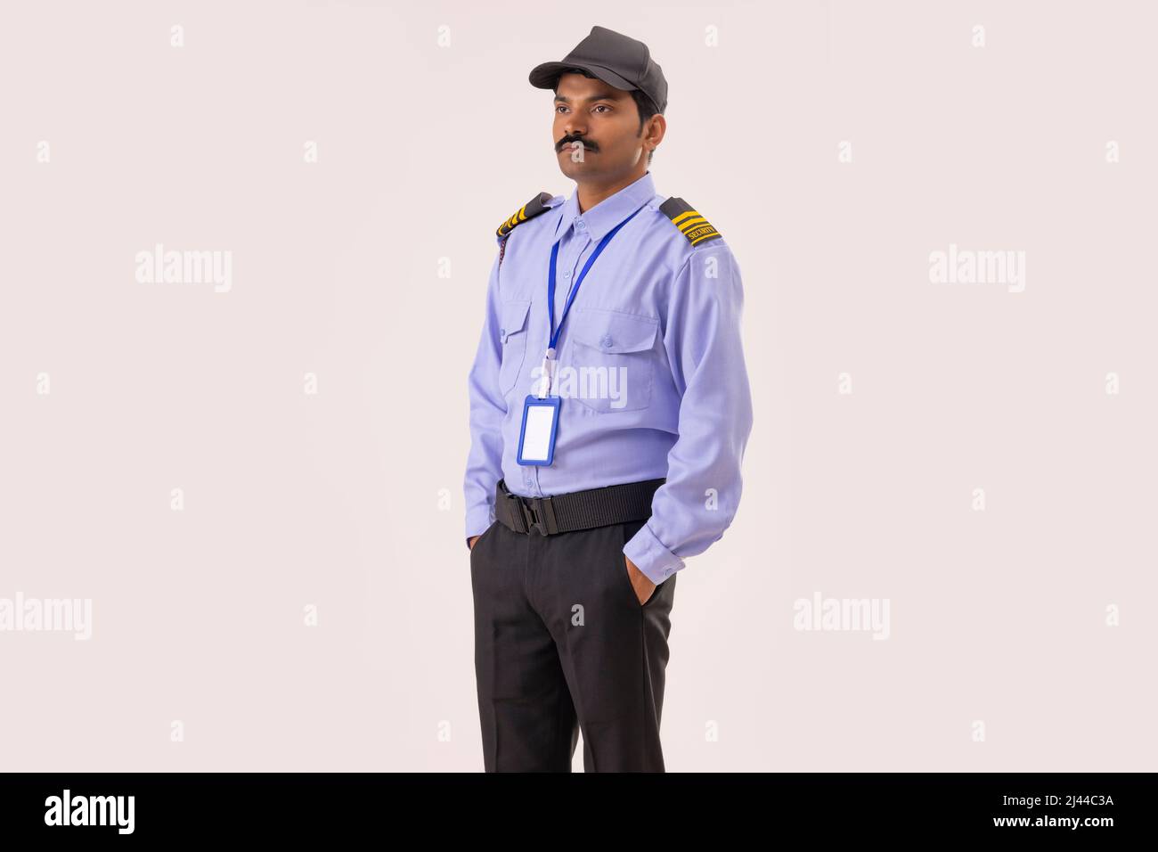 Portrait of Security guard looking elsewhere with hands in pockets ...
