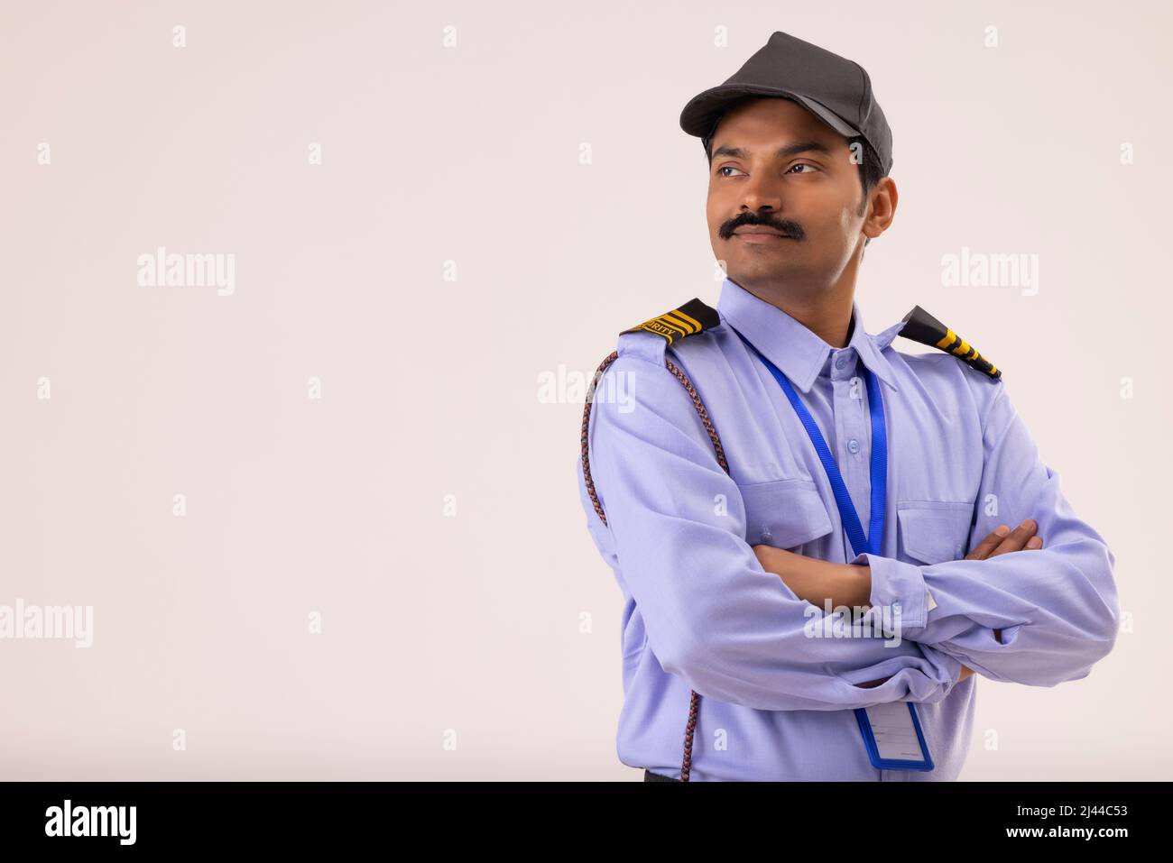 Portrait of Security guard looking elsewhere with arms folded Stock ...