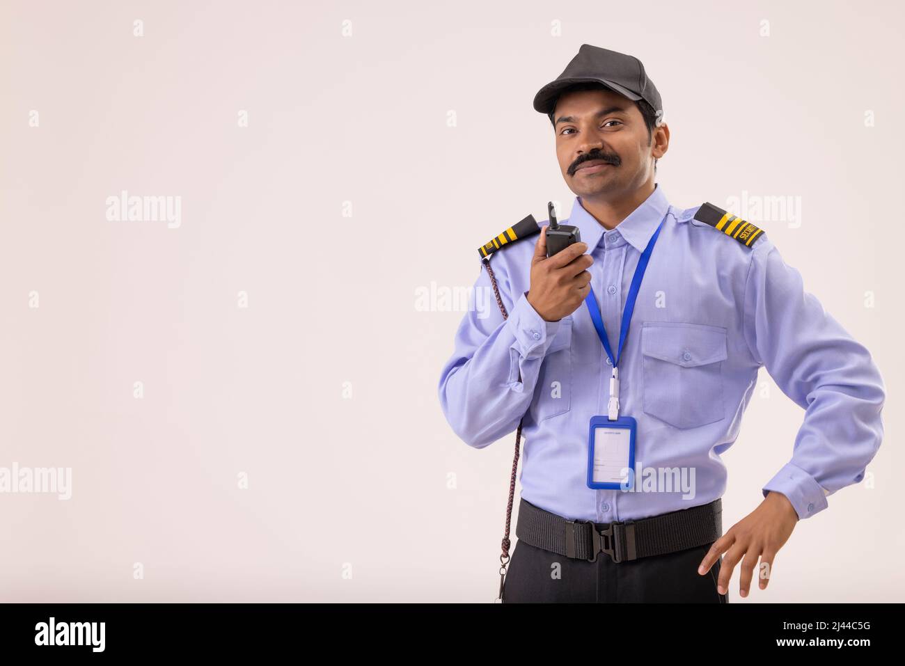 Portrait of Security guard talking over walkie talkie Stock Photo - Alamy