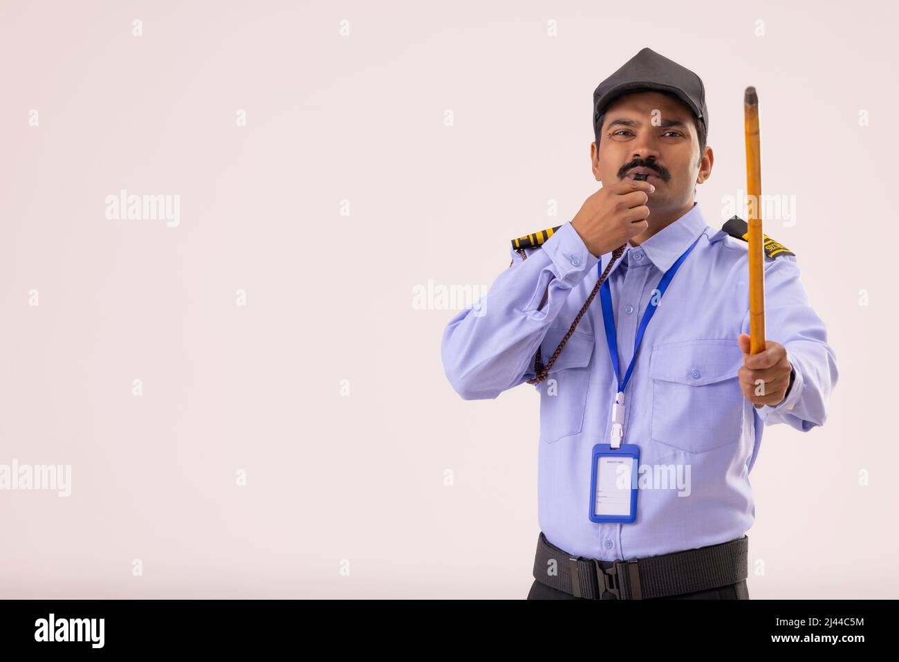 Portrait of Security guard blowing whistle with stick in his hand Stock ...
